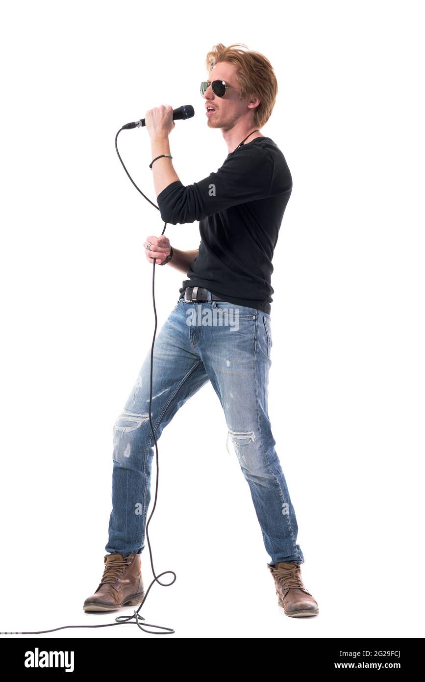 Passionate rock music singer singing loud on microphone with energy ...