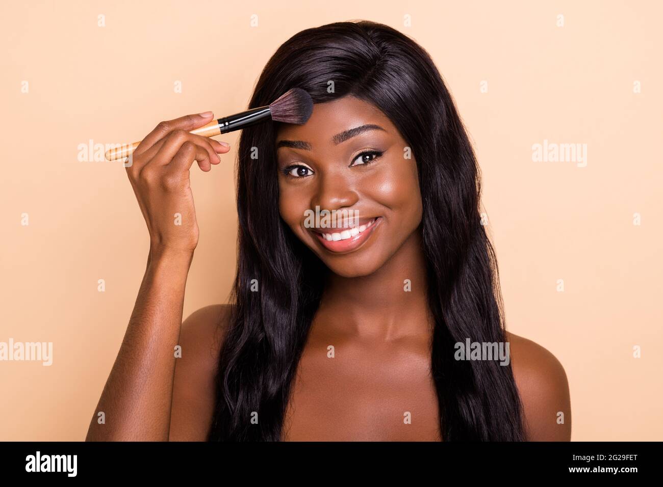 Portrait of attractive cheerful girl applying cc cream preparing ...