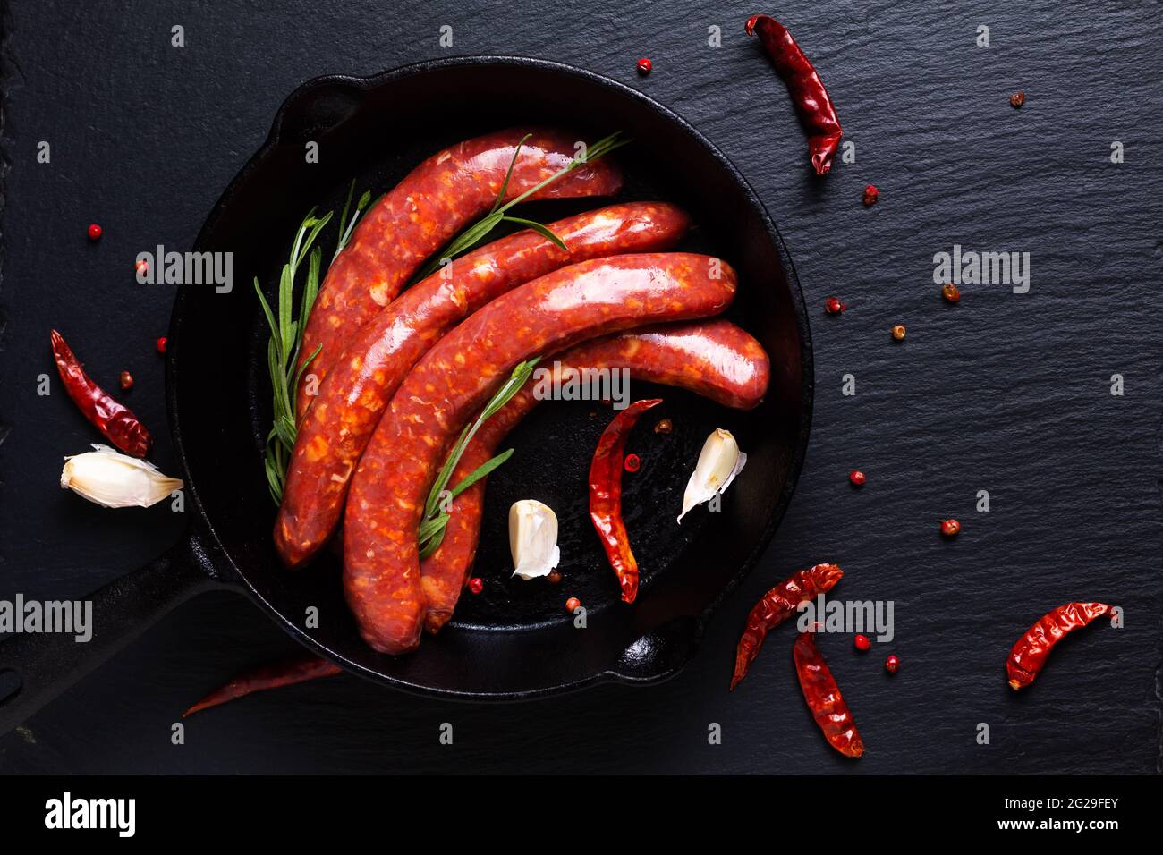 Food concept Merguez French spicy sausages in skillet iron pan with ...