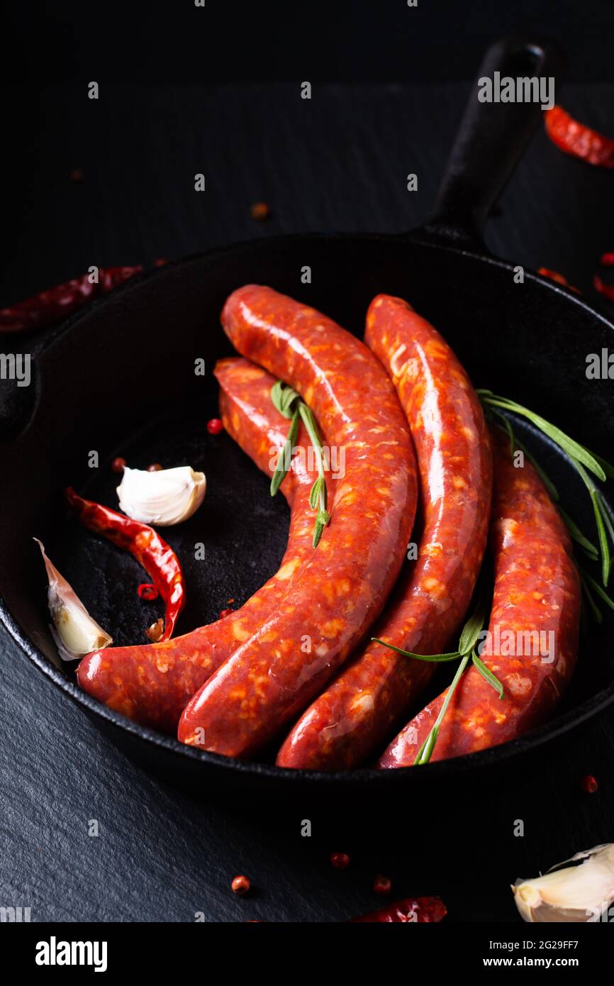 Food concept Merguez French spicy sausages in skillet iron pan with ...