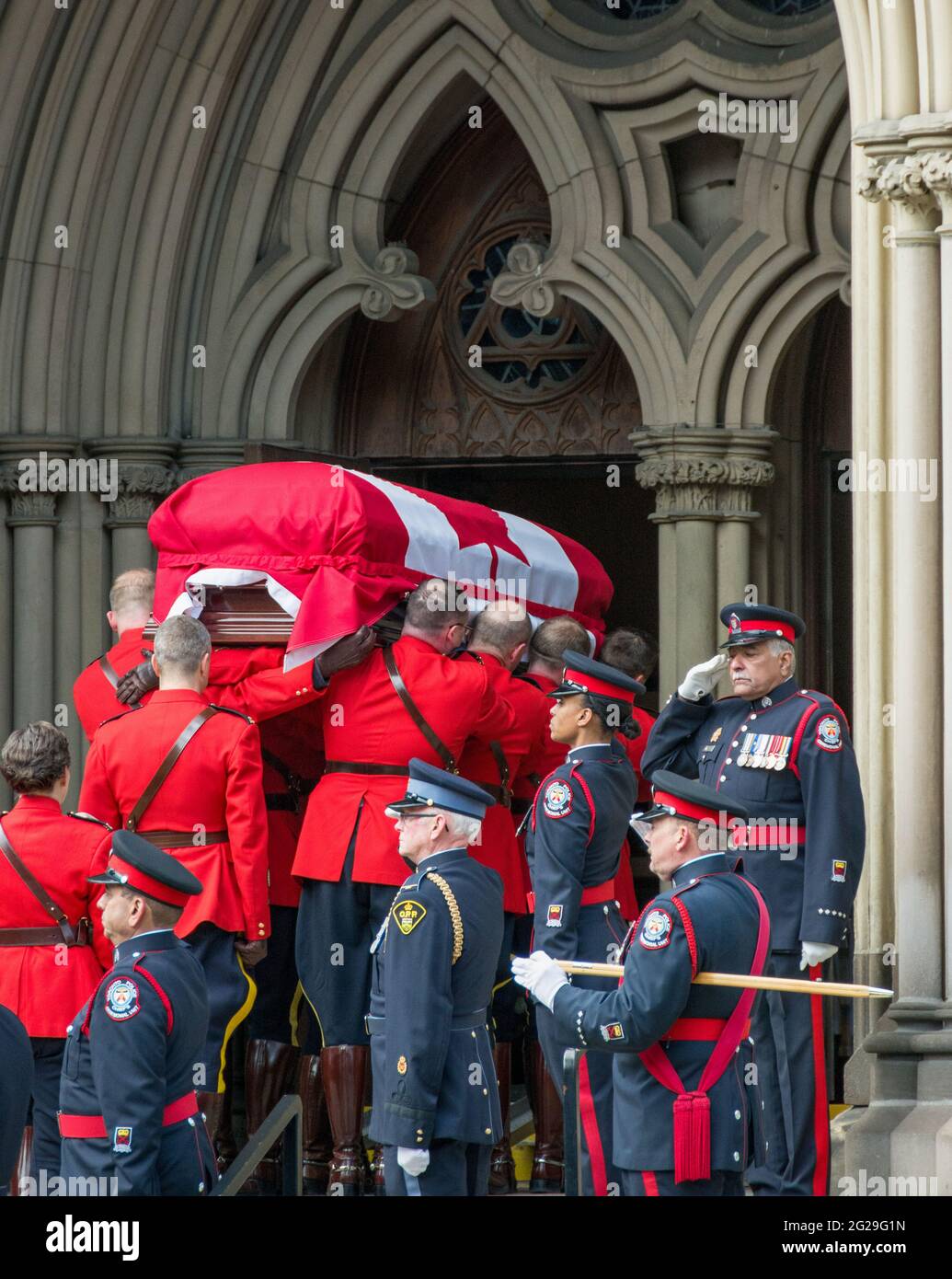 TORONTO, CANADA-APRIL 16, 2014RCMP getting the Flaherty's coffin out ...