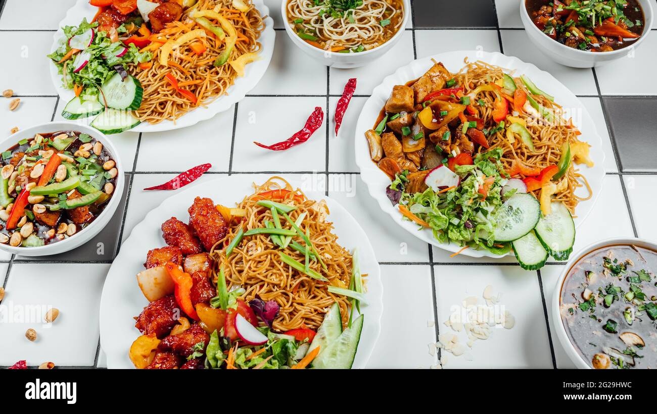 Variety of food including noodles, spicy chicken wings, soup and ...