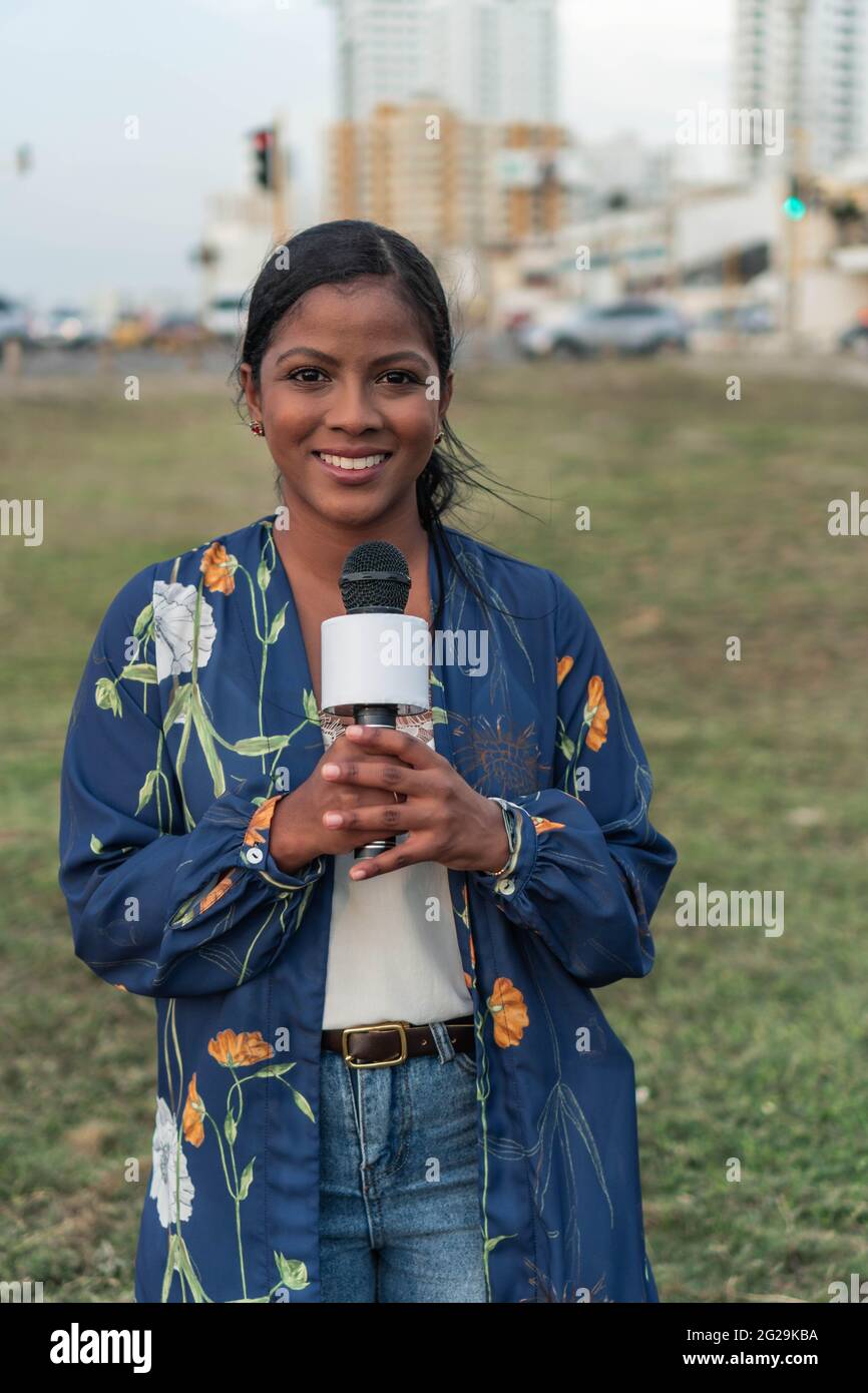 African American Woman Journalist Speaking Into Microphone While
