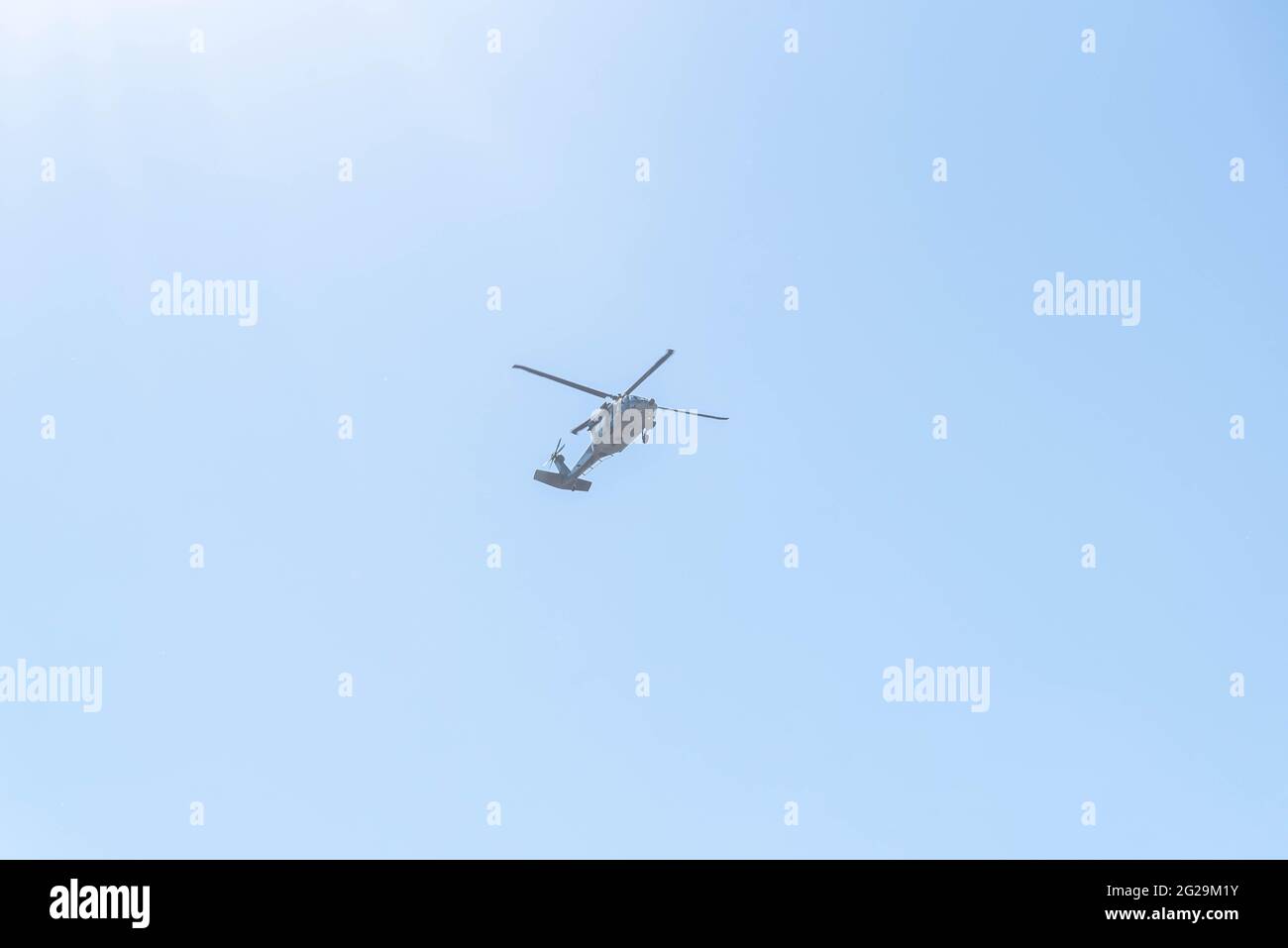 Military helicopter on blue background. Military aircraft. Flyby ...