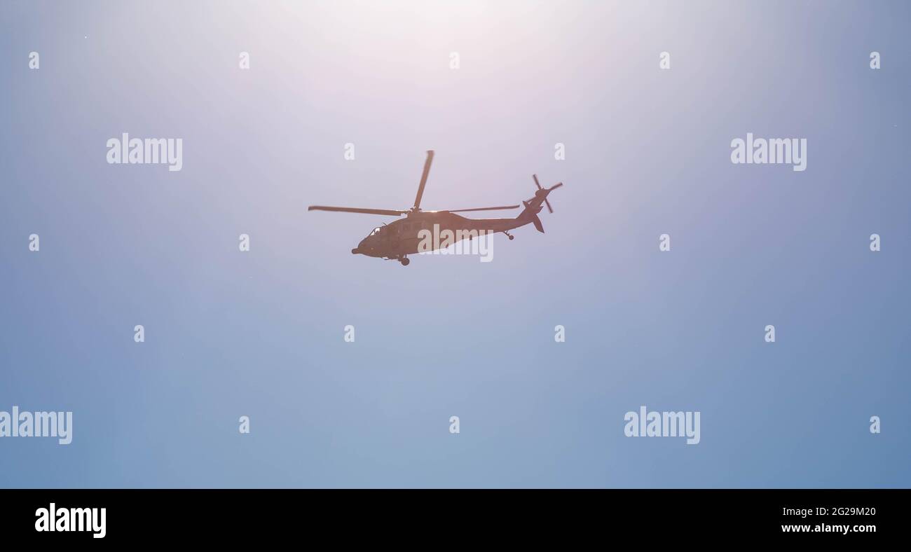 Military helicopter on blue background. Military aircraft. Flyby ...