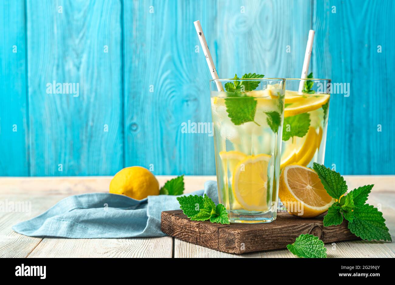 Summer drink with lemon and mint in two clear glasses. Lemonade. Side ...