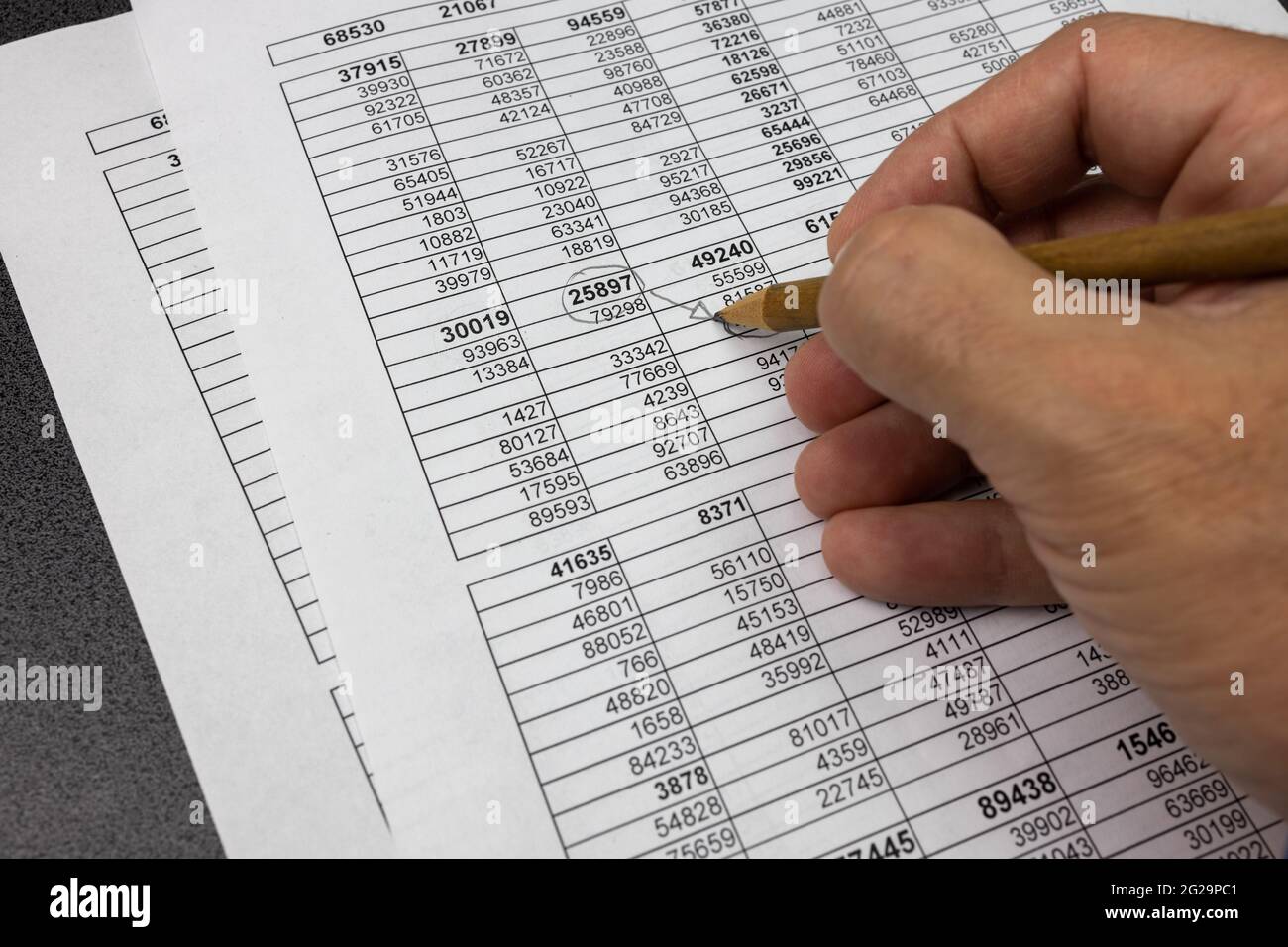 Person analyzing accounting document pointing out some data with a ...