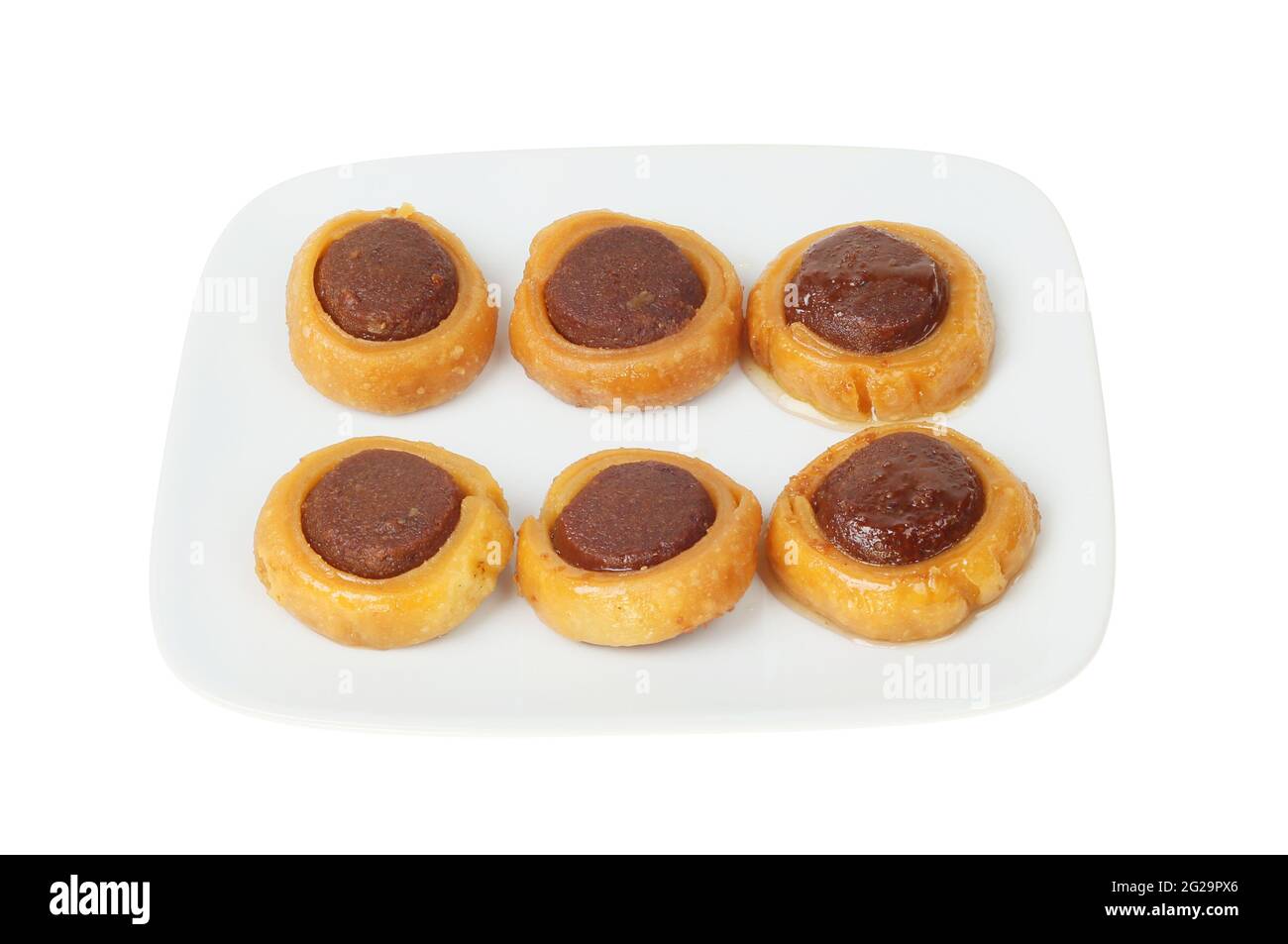 Greek style roxakia on a plate isolated against white Stock Photo - Alamy