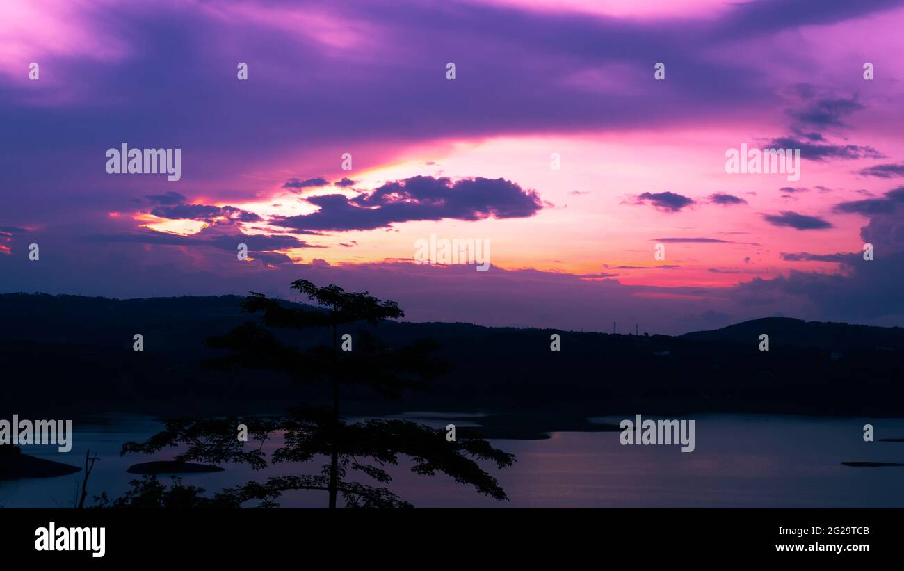 Colorful evening sky as the sun descends below the horizon at Umiam ...