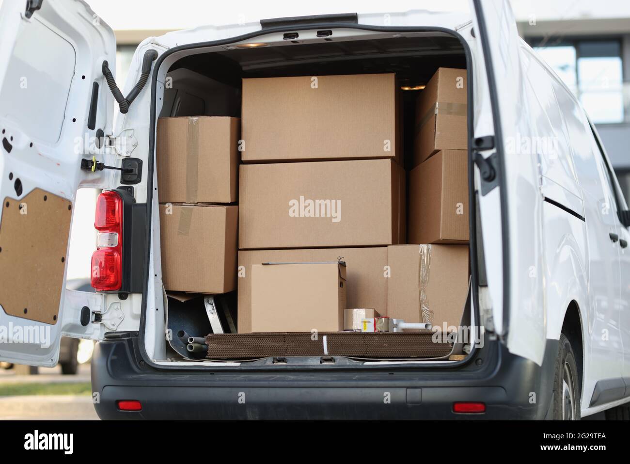Lot of cardboard boxes are in minivan with open door closeup Stock ...
