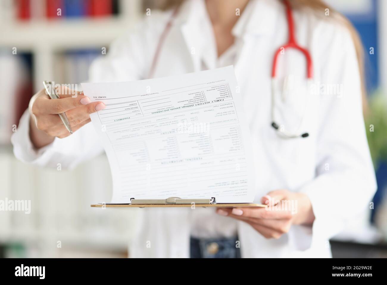 Doctor flipping through documents in patient medical history in clinic ...