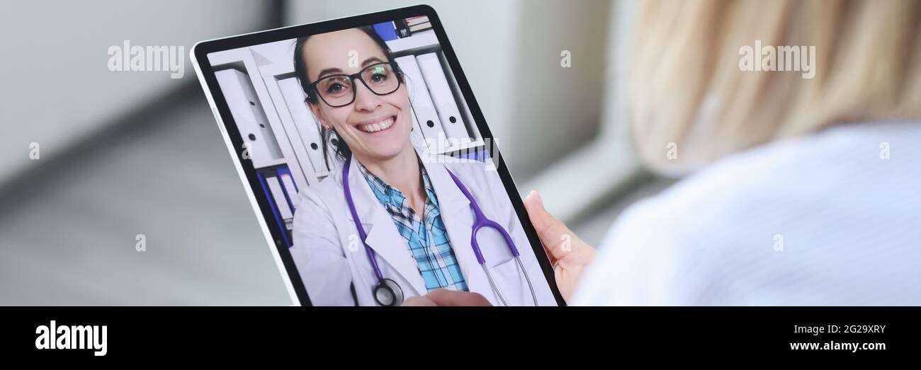 Patient consults with doctor via video call on tablet Stock Photo - Alamy