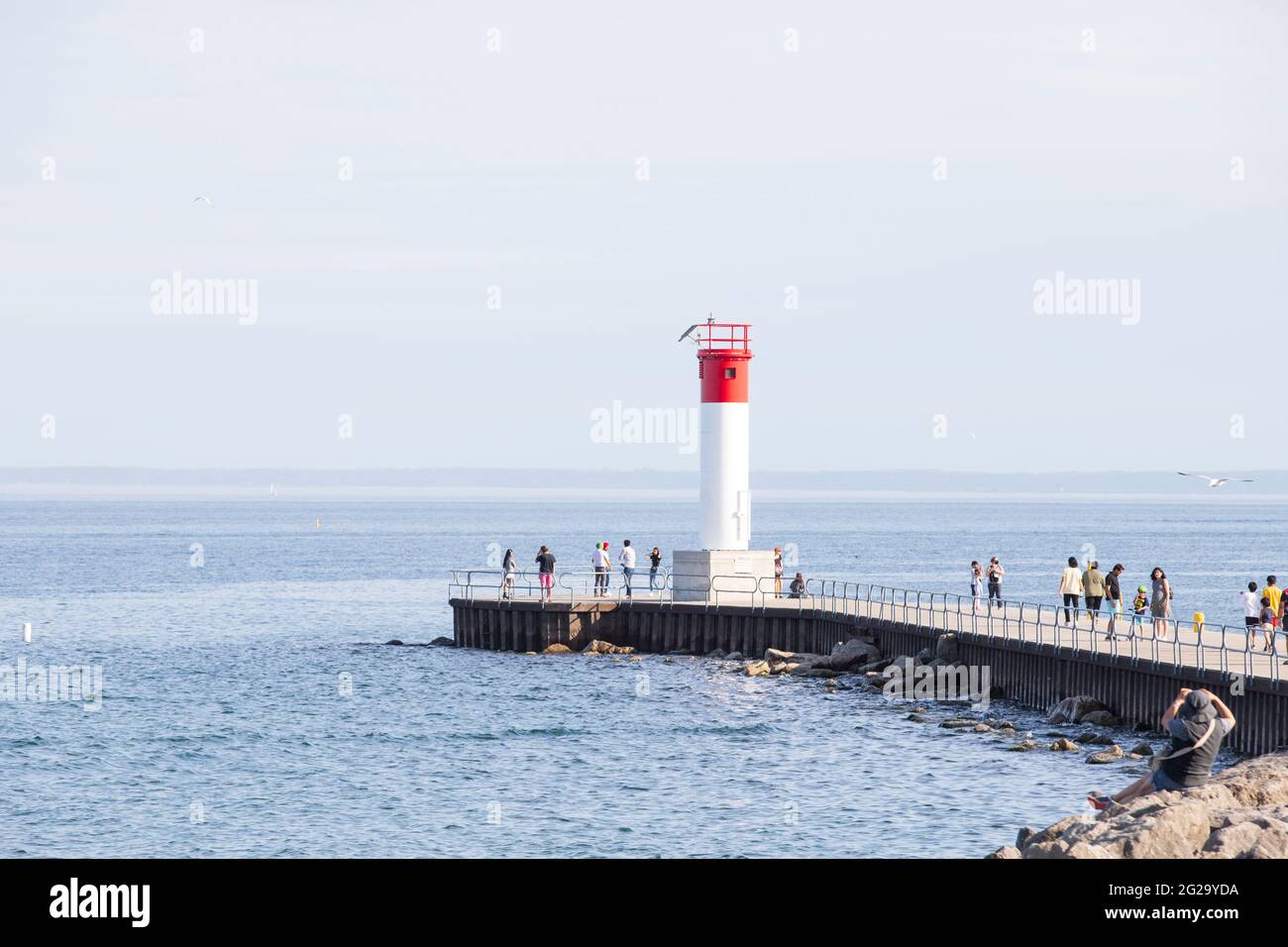 Oakville lighthouse is surrounded by many visitors enjoying the scenery ...