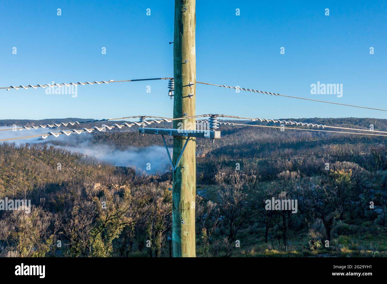 Drone aerial photograph of a telephone pole and wires in a forest ...