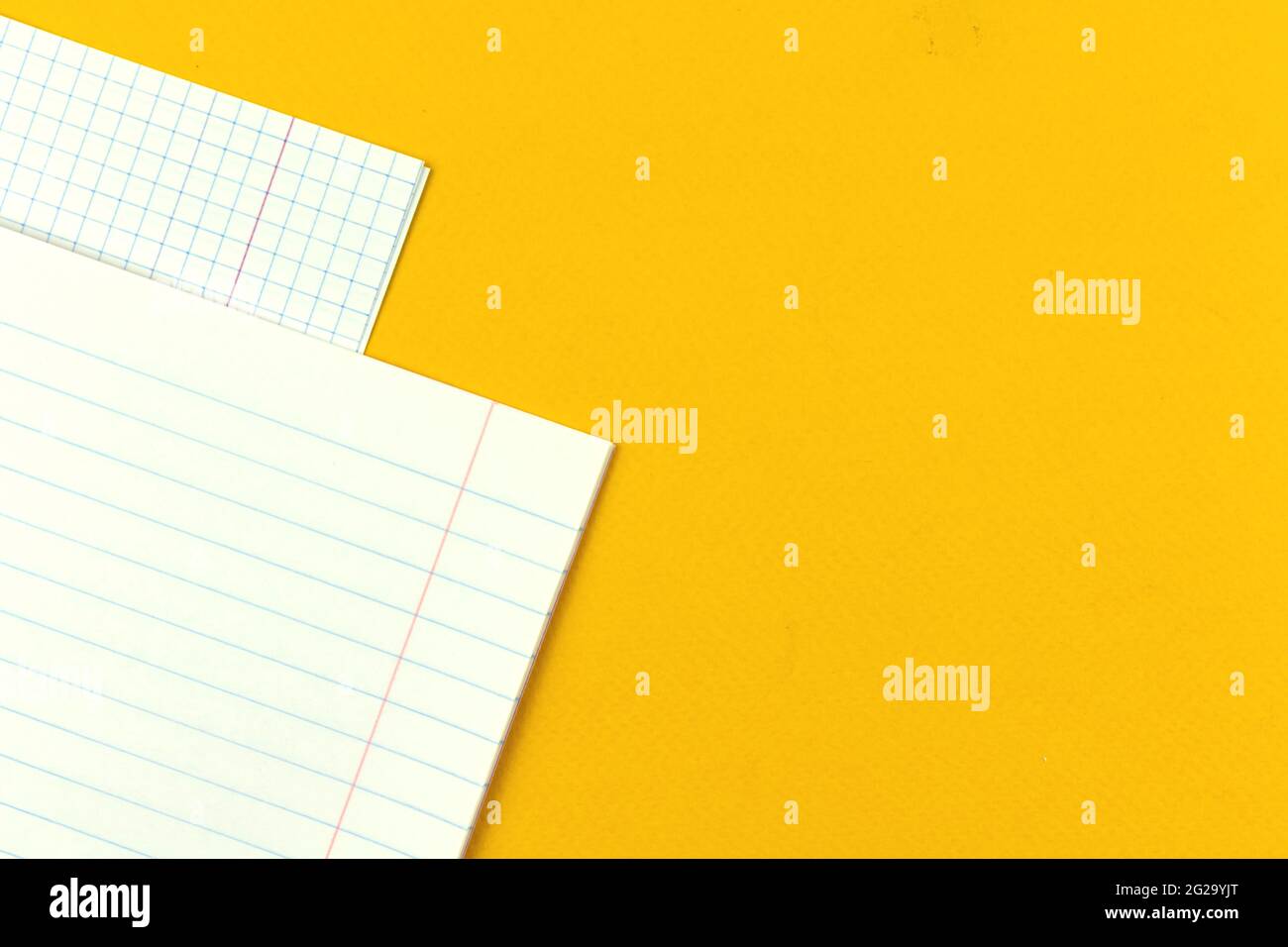 Blank pages of a school notebook close-up on a yellow table desktop ...