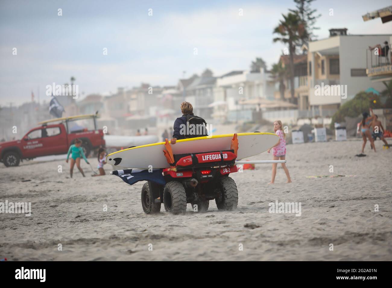 Lifeguard riding a buggy at the ocean beach at sunset. Del Mar, San ...