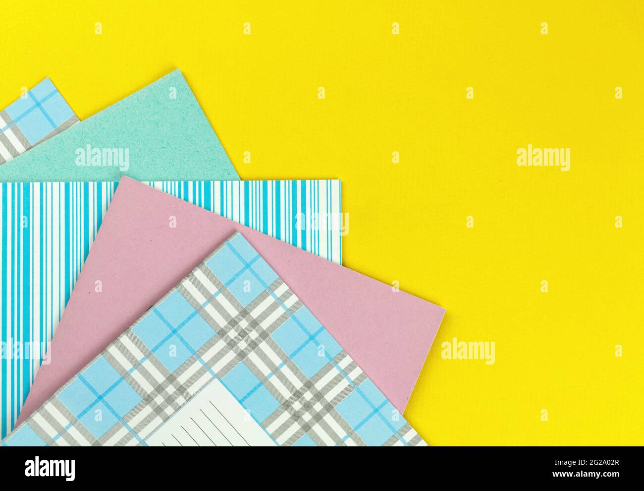 School exercise books on bright yellow desktop, elemntary school ...