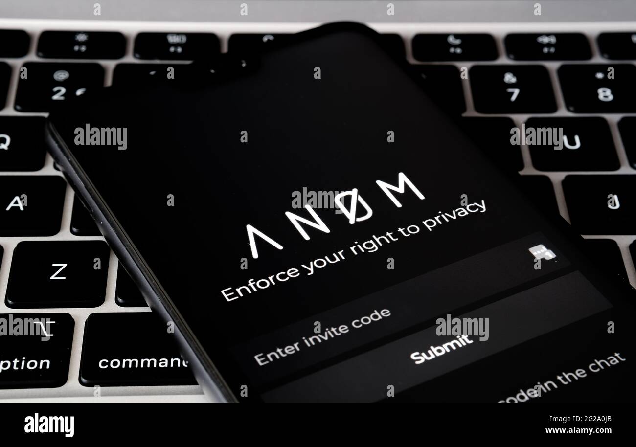 ANOM app logo seen on the smartphone and laptop on blurred background ...