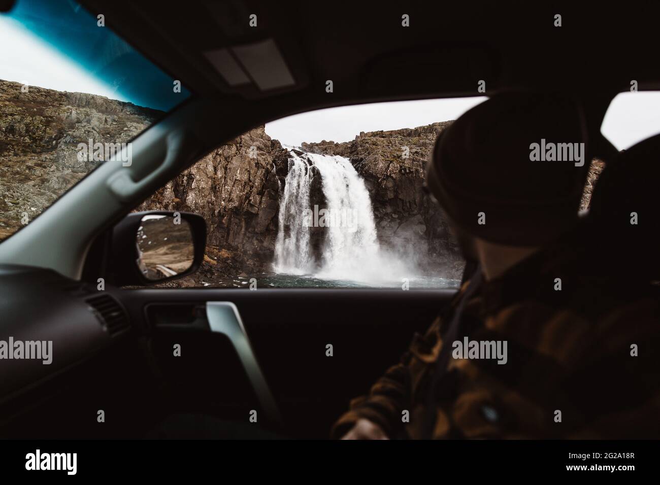 Tourist in car looking at waterfall Stock Photo - Alamy