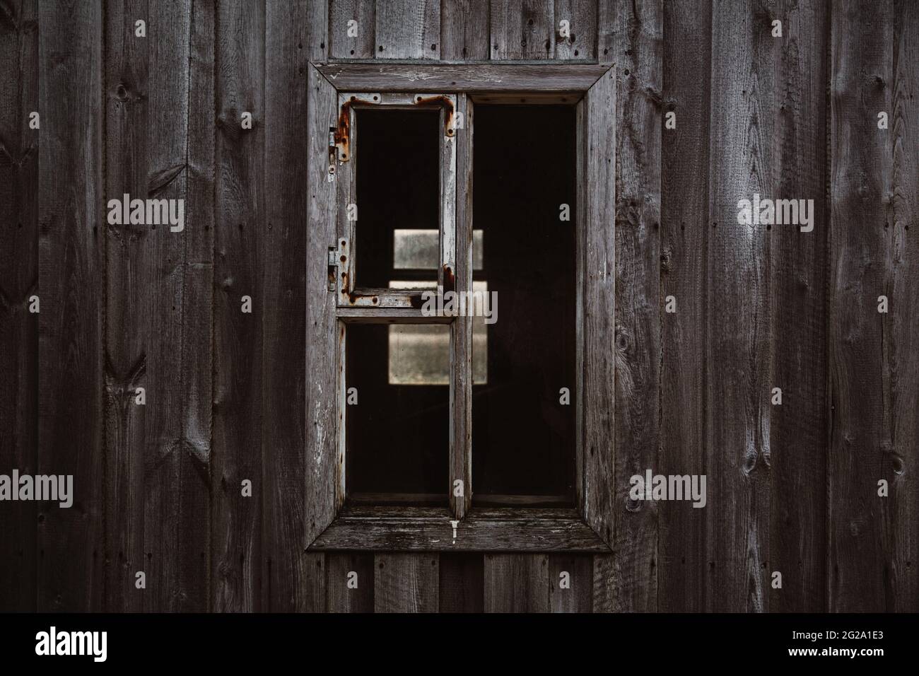 Exterior of wooden window frame without glass in abandoned old hut ...