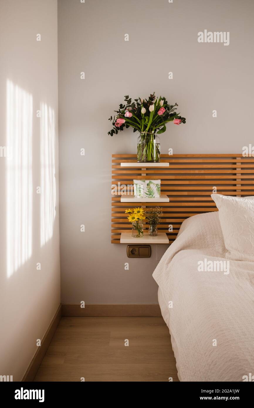 Side view of athletic female runner leaning on pillar and stretching ...