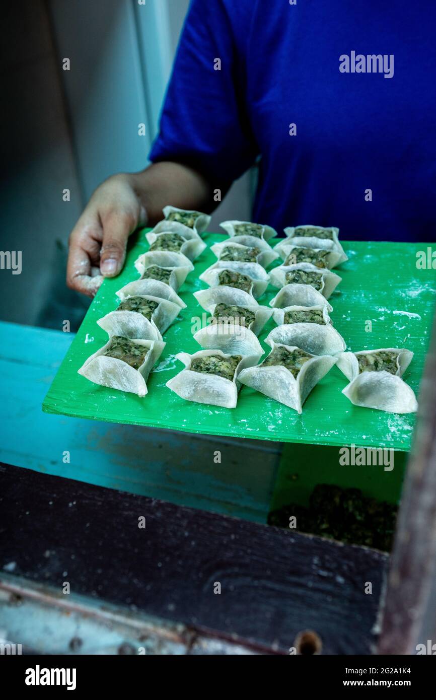 Cropper unrecognizable person hands carrying tray with dim sum made old ...