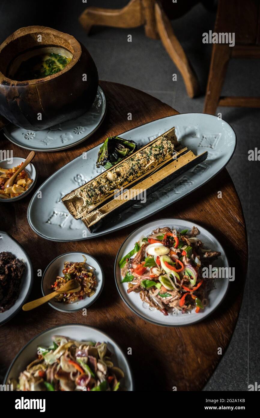 From above served round wooden table with different appetite dishes of ...