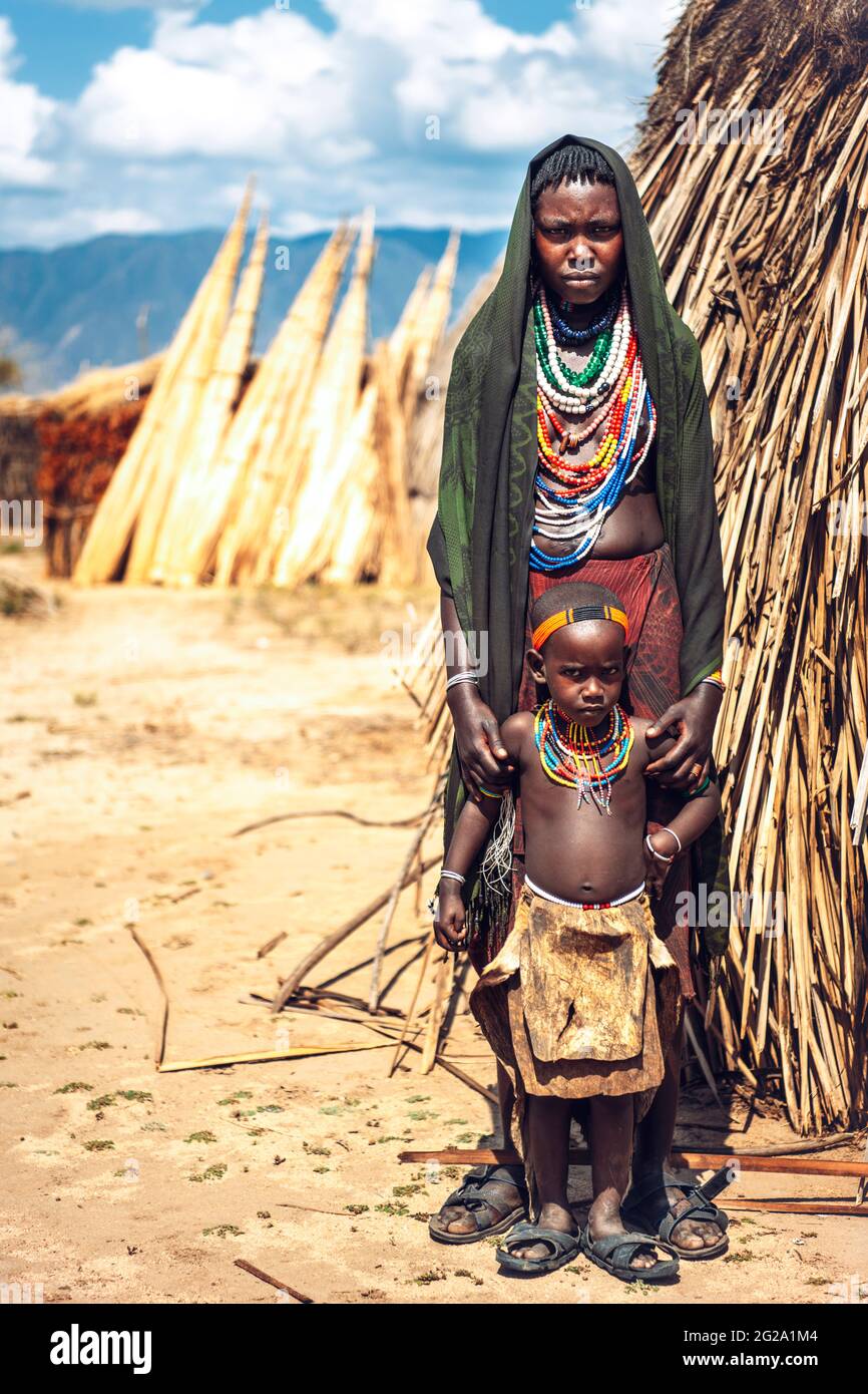 Woman in traditional clothes with her son in Arbore tribe village, Omo ...