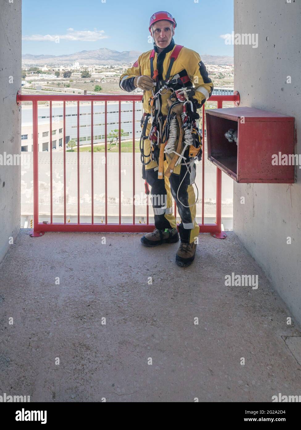 Professional fireman climber in uniform getting ready for climbing ...
