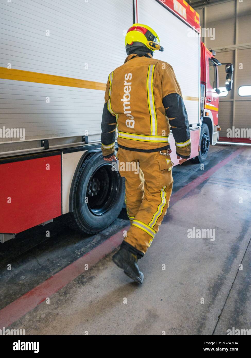 back view of Fireman walking in fire department near fire truck Stock ...