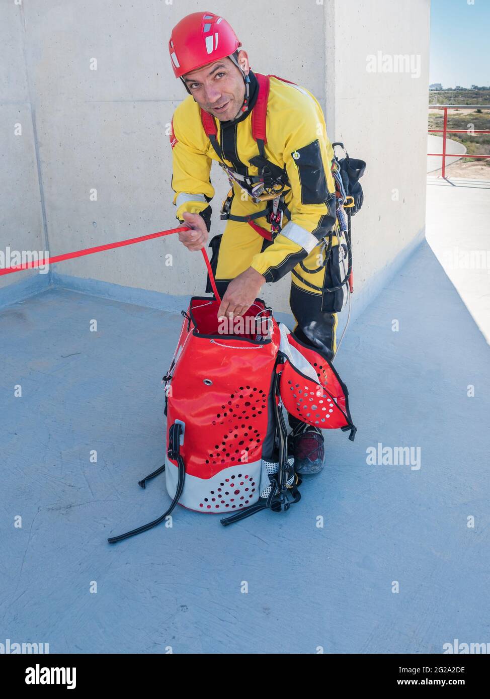 Professional fireman climber in uniform getting ready for climbing ...