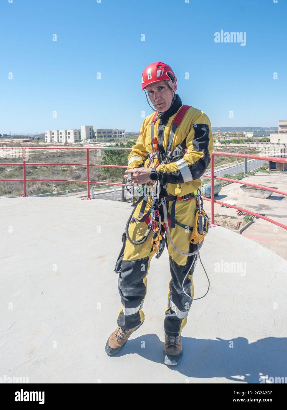 Professional fireman climber in uniform getting ready for climbing ...