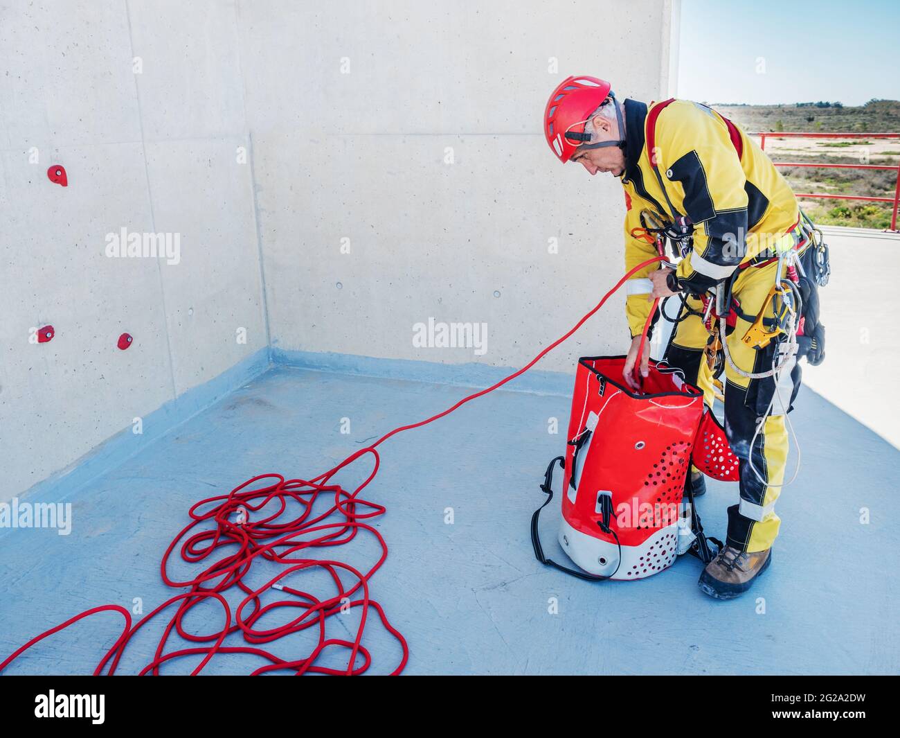 Professional fireman climber in uniform getting ready for climbing ...