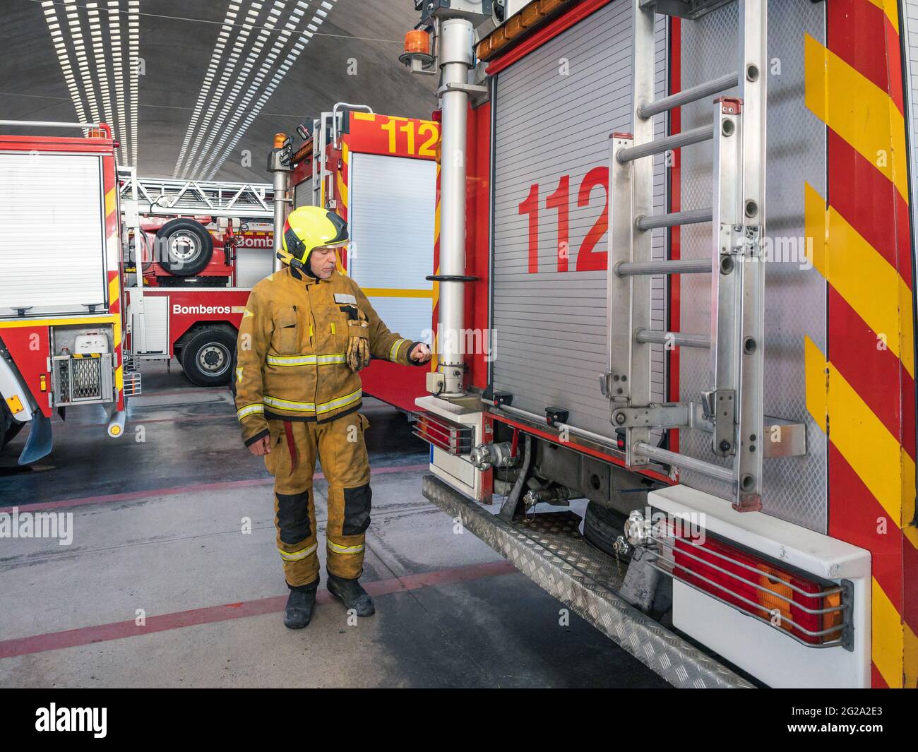 Fireman standing and leaning in fire truck into a fire department ...