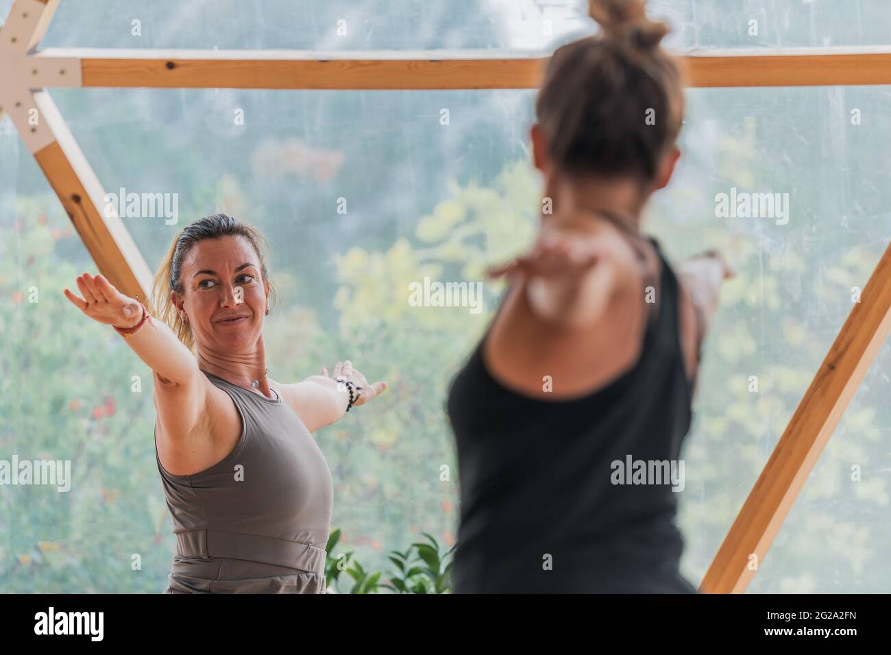 Back view of balanced group of people concentrated on stretching ...