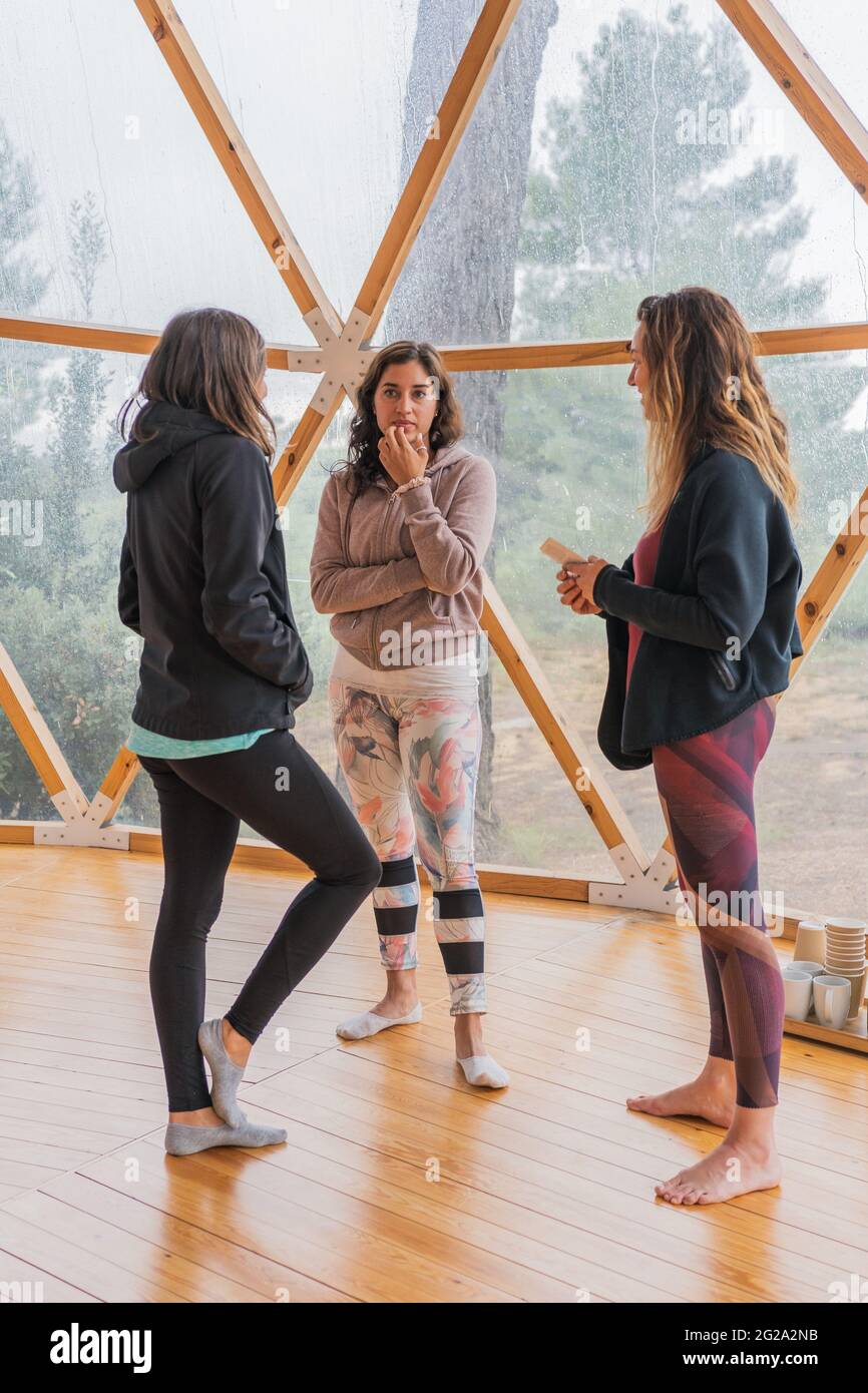 Side view of long haired women attentively explaining information to ...