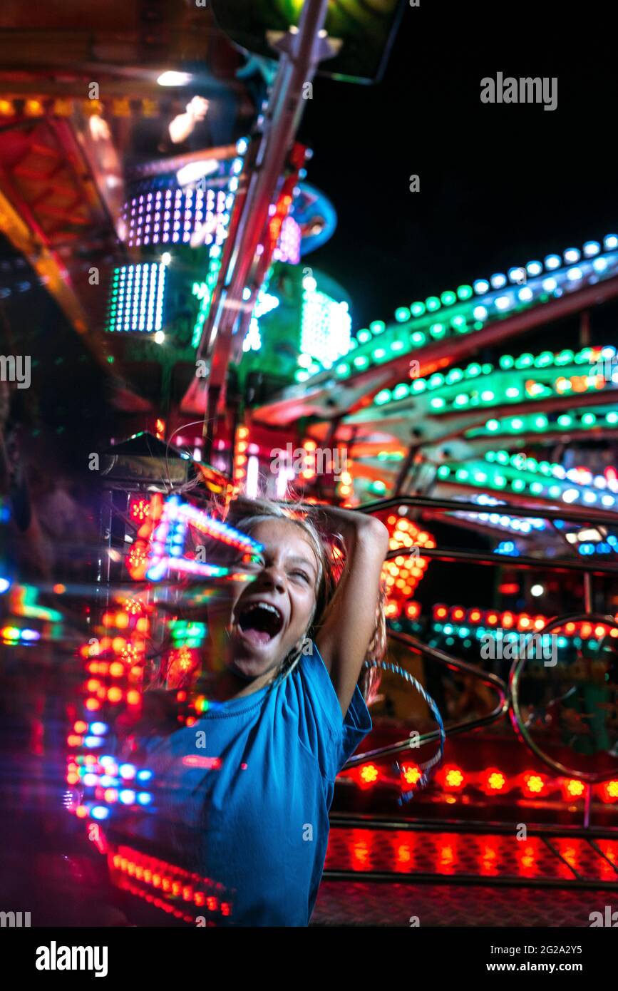 Little girl having exciting experience in the roller coaster. Motion ...