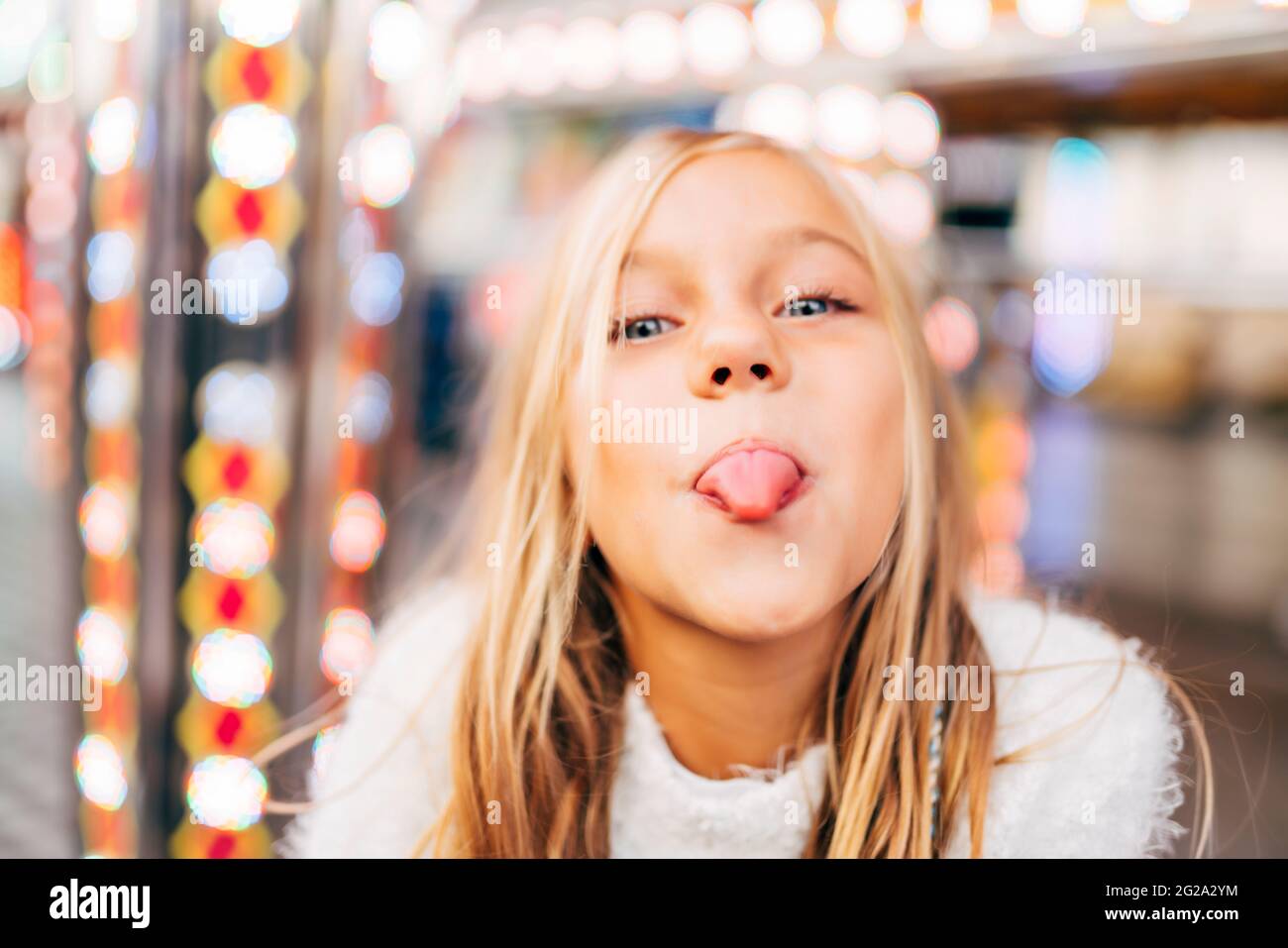 Little girl has fun at the fair with lights Stock Photo - Alamy