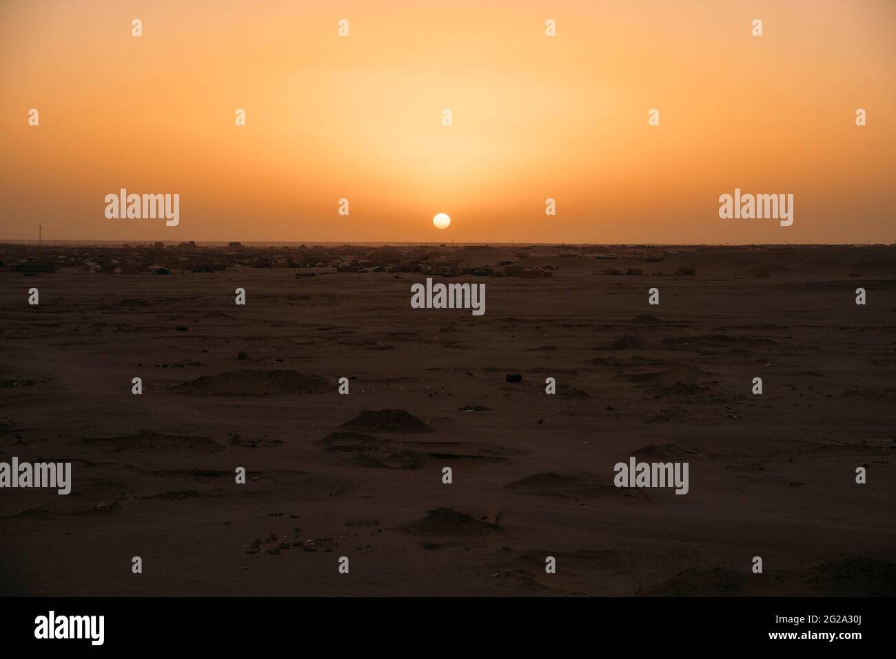 Amazing view of cloudless evening sky with setting sun over dry sand of ...