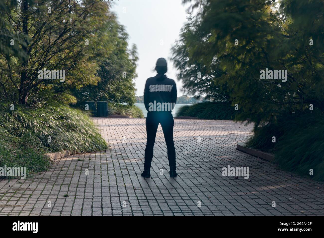 Female security guard in uniform watching over a park Stock Photo - Alamy