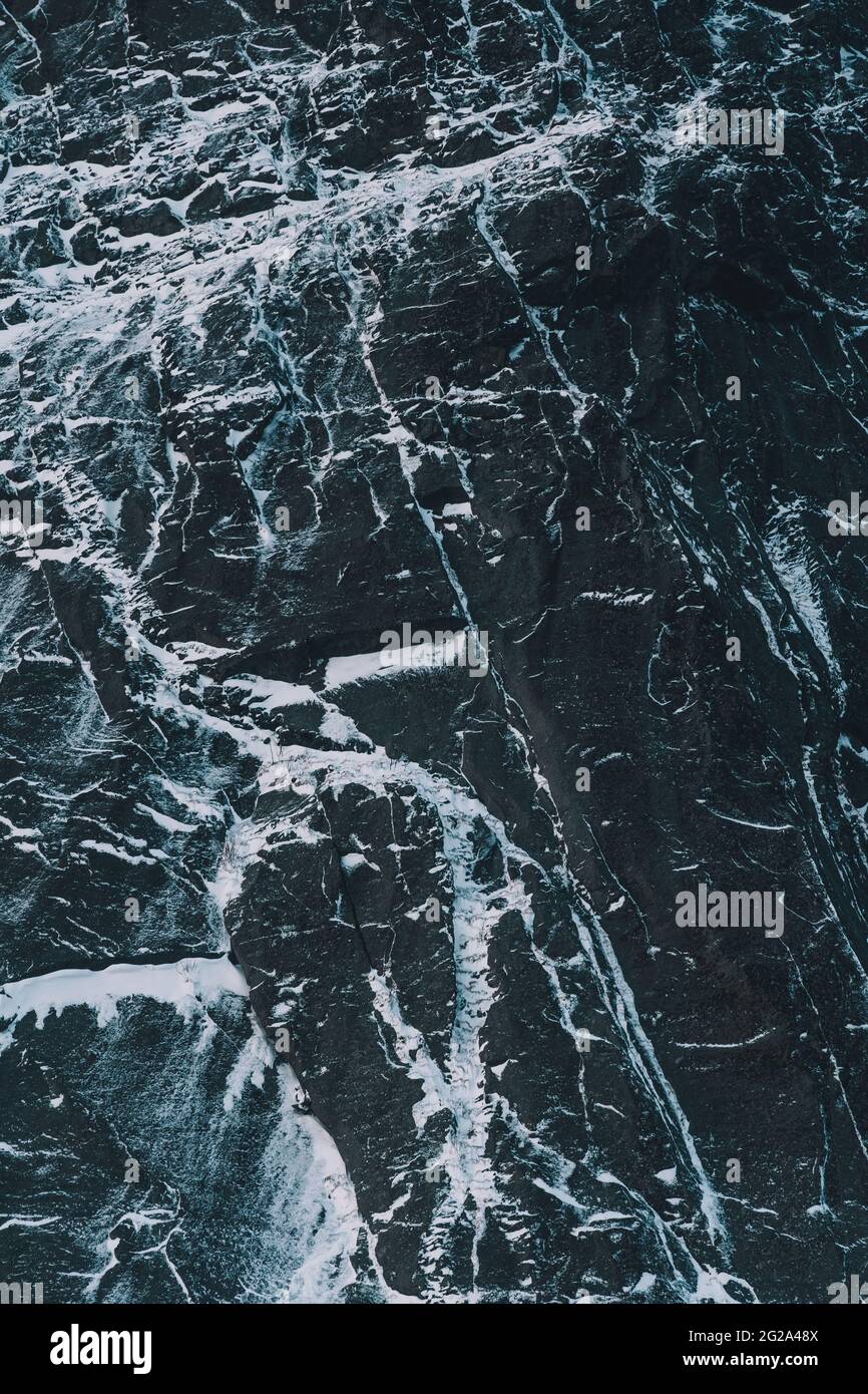 detail of black rock with snow in arctic island Stock Photo - Alamy