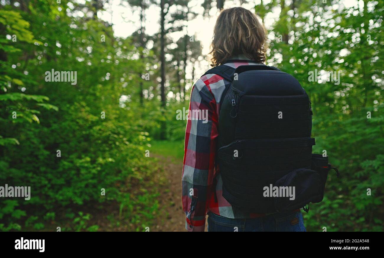 Man with backpack and sunglasses in the woods. Arc shoot Stock Photo ...