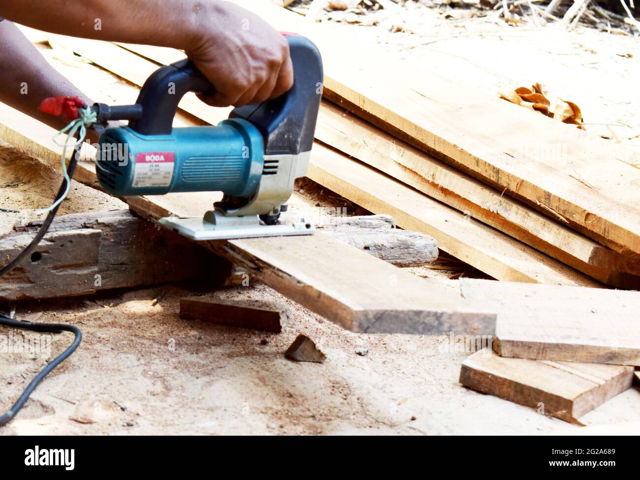 Man planed board Electrical plane. Construction, wood processing Stock ...
