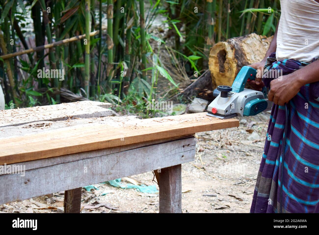Man planed board Electrical plane. Construction, wood processing Stock ...