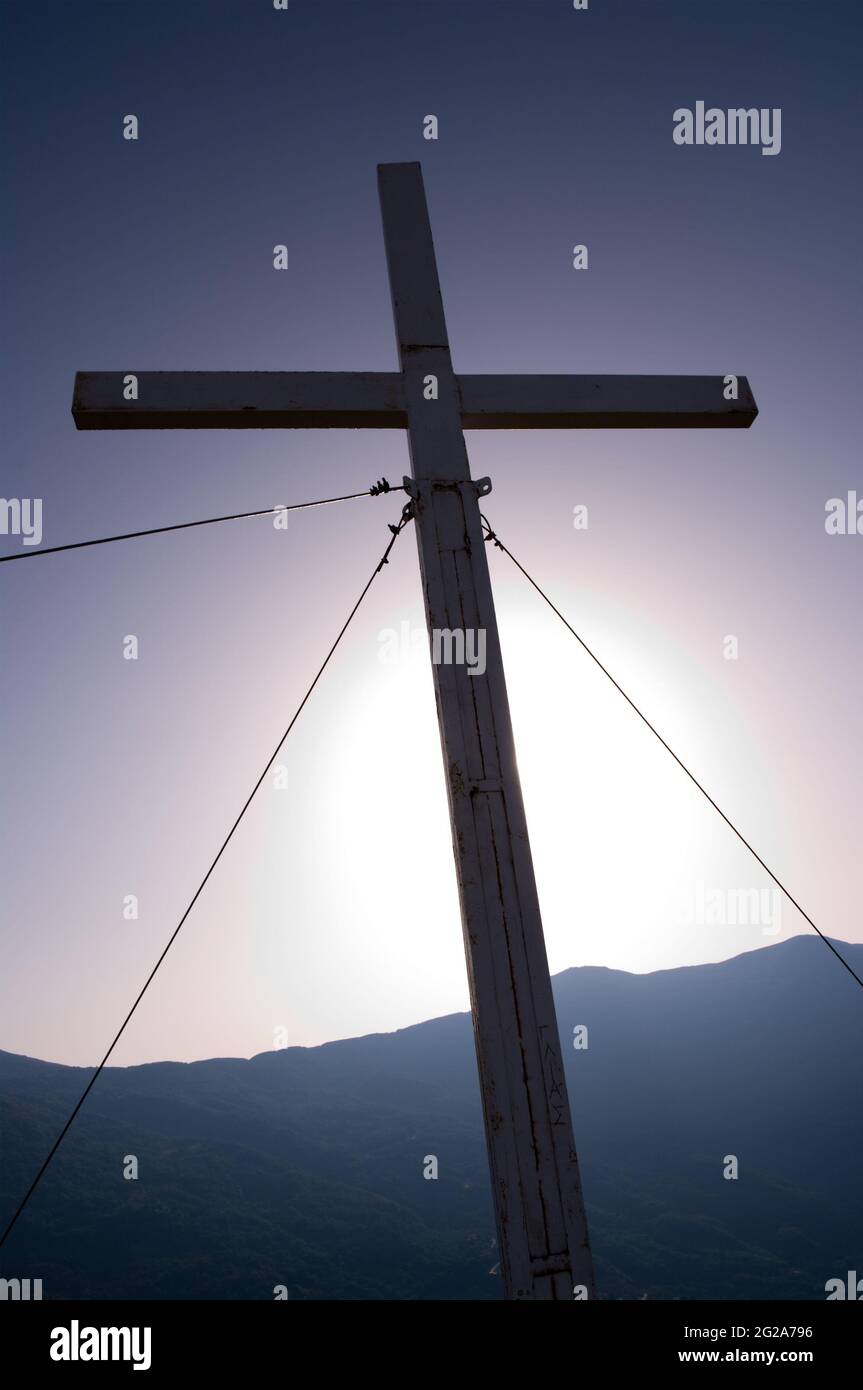 a cross in backlight against the sky blue Stock Photo - Alamy