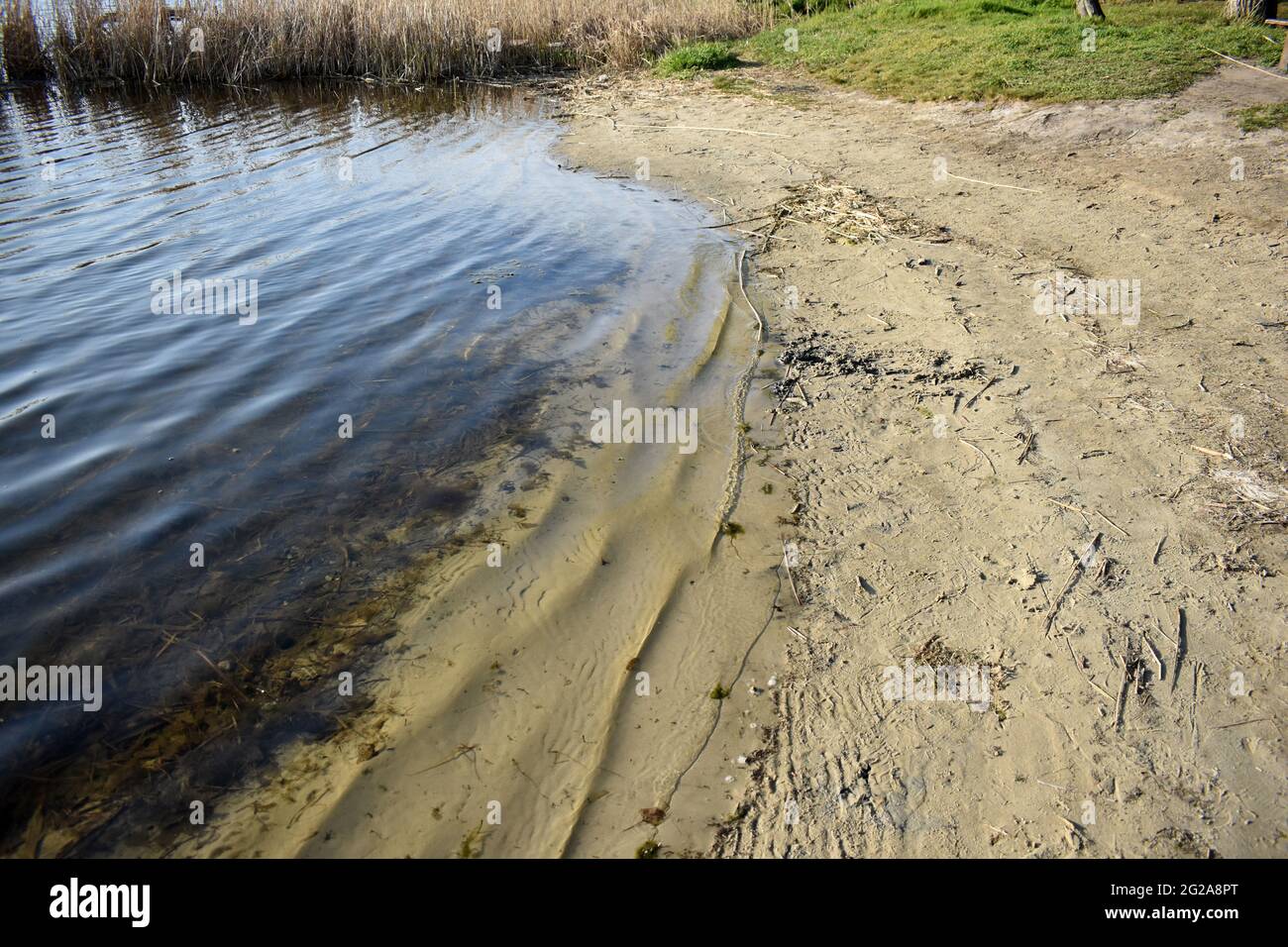 Sand on the lakeshore during the daytime Stock Photo - Alamy