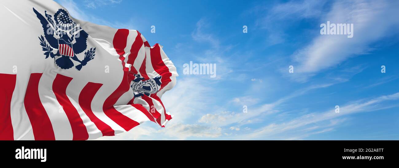 flag of Ensign of the United States Coast Guard waving in the wind. USA ...