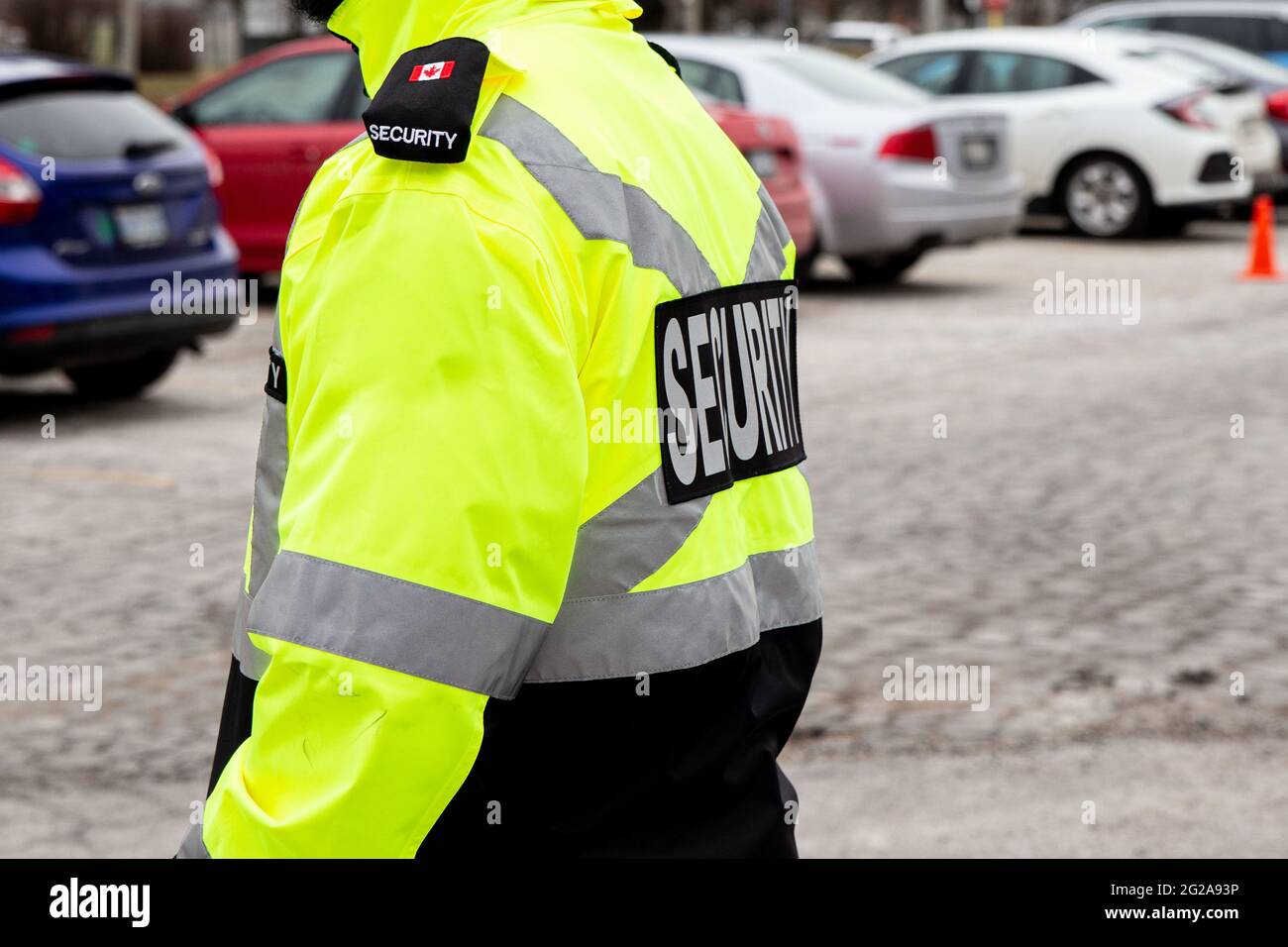 Security guard in a uniform watching over the parking area Stock Photo ...