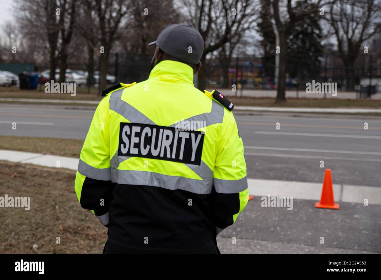 Rear view of a security guard watching over the parking area Stock ...