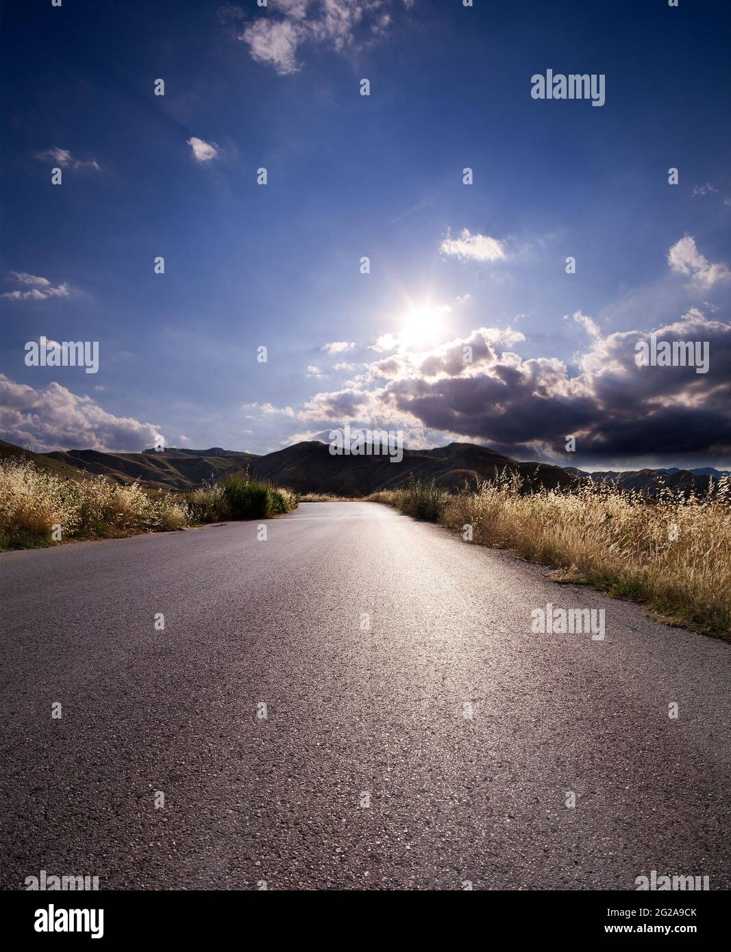 asphalt of country road in backlit Stock Photo - Alamy